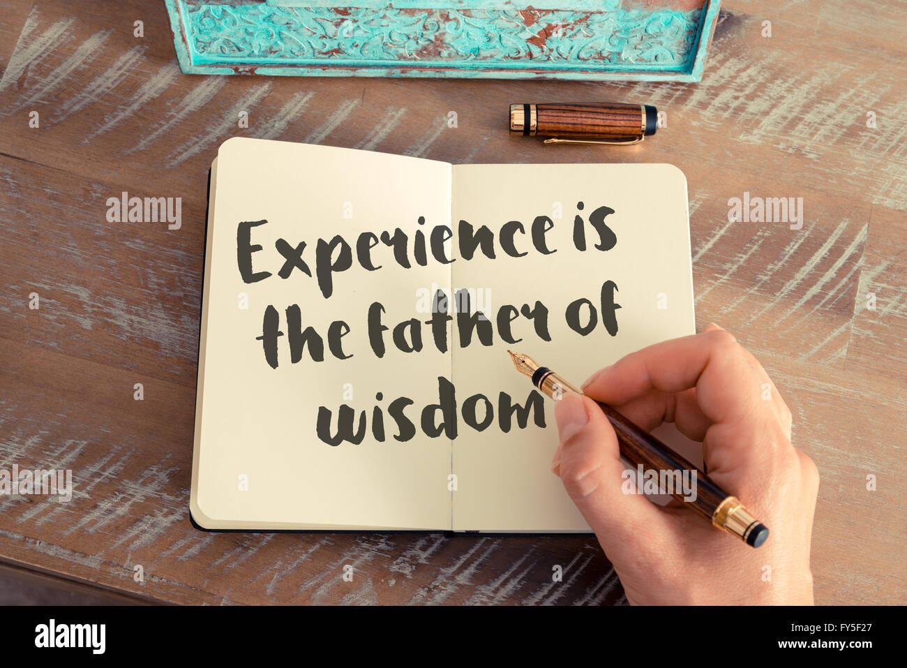 Handwritten quote Experience is the father of wisdom Stock Photo - Alamy