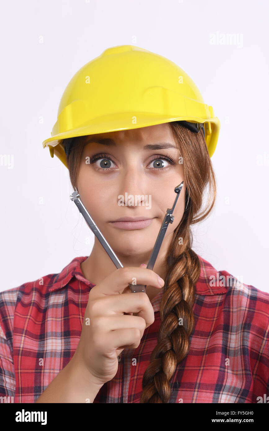 Portrait of beautiful woman construction worker with a compass ...