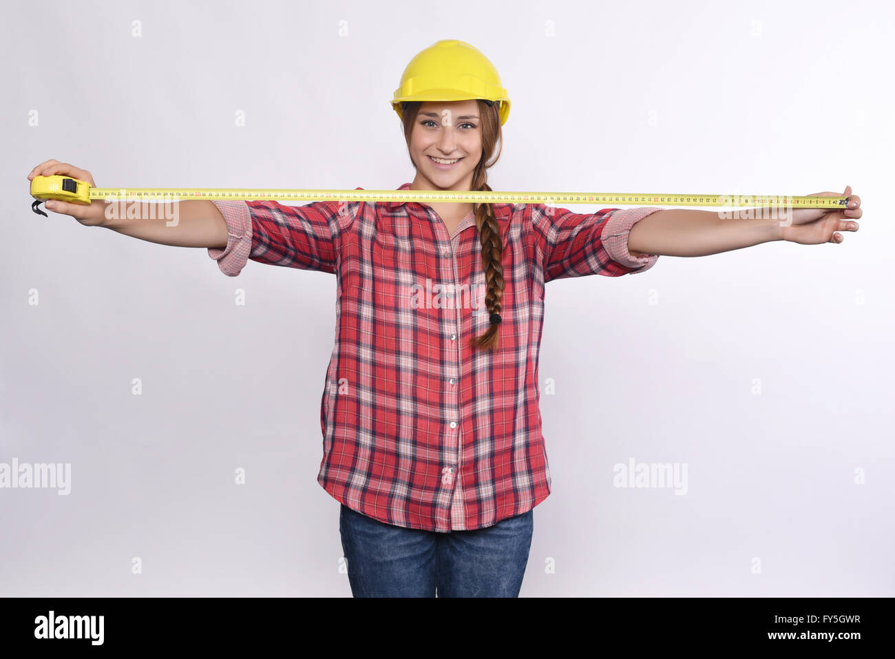 Portrait of beautiful woman construction worker taking measures with a ...