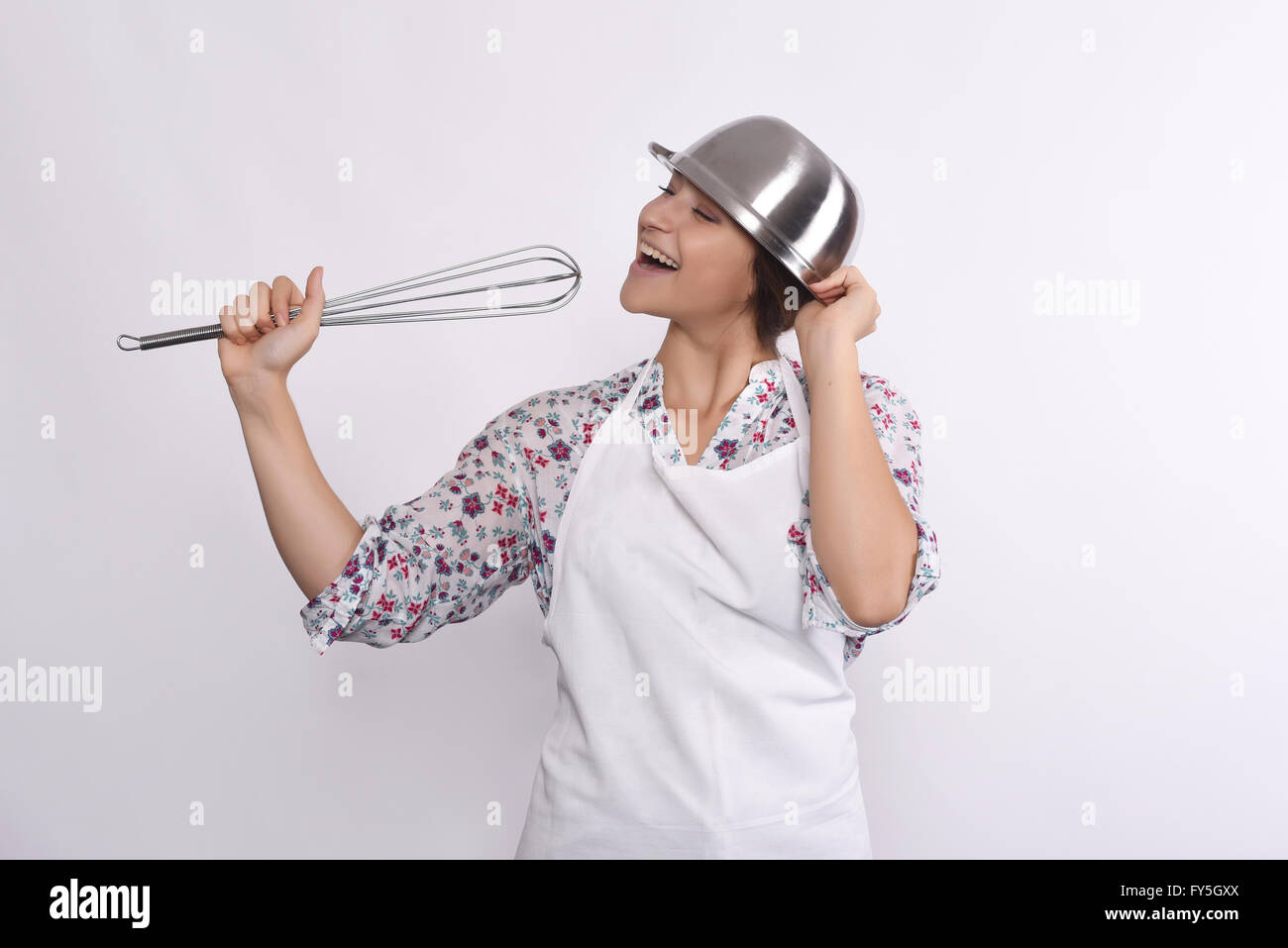 Portrait of young beautiful chef having fun. Isolated white background ...