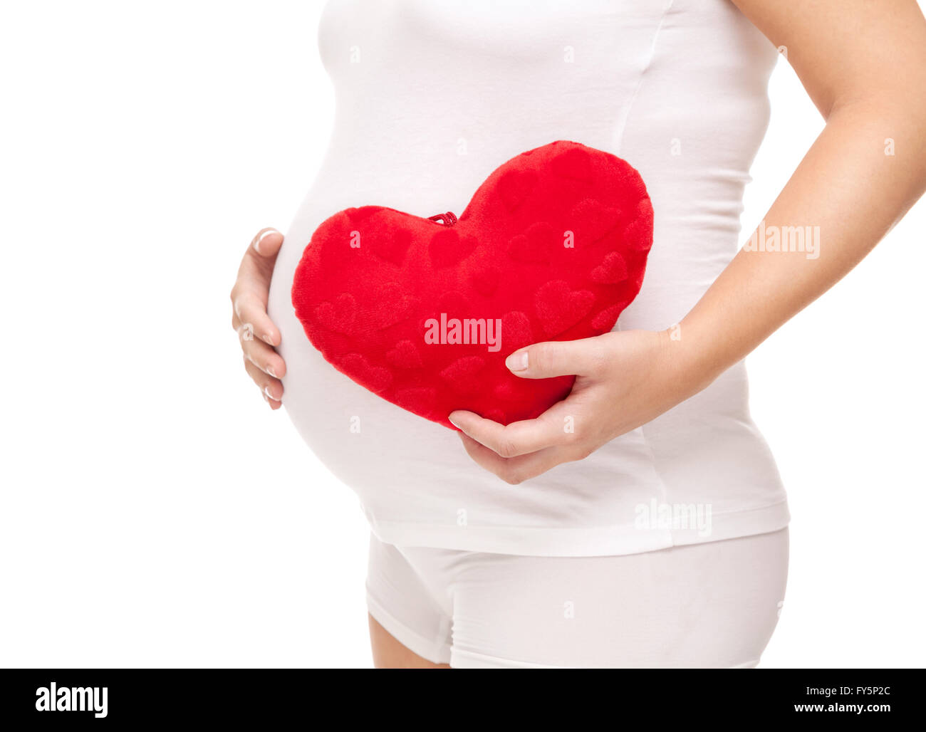 Pregnant woman holding a heart isolated on white Stock Photo - Alamy