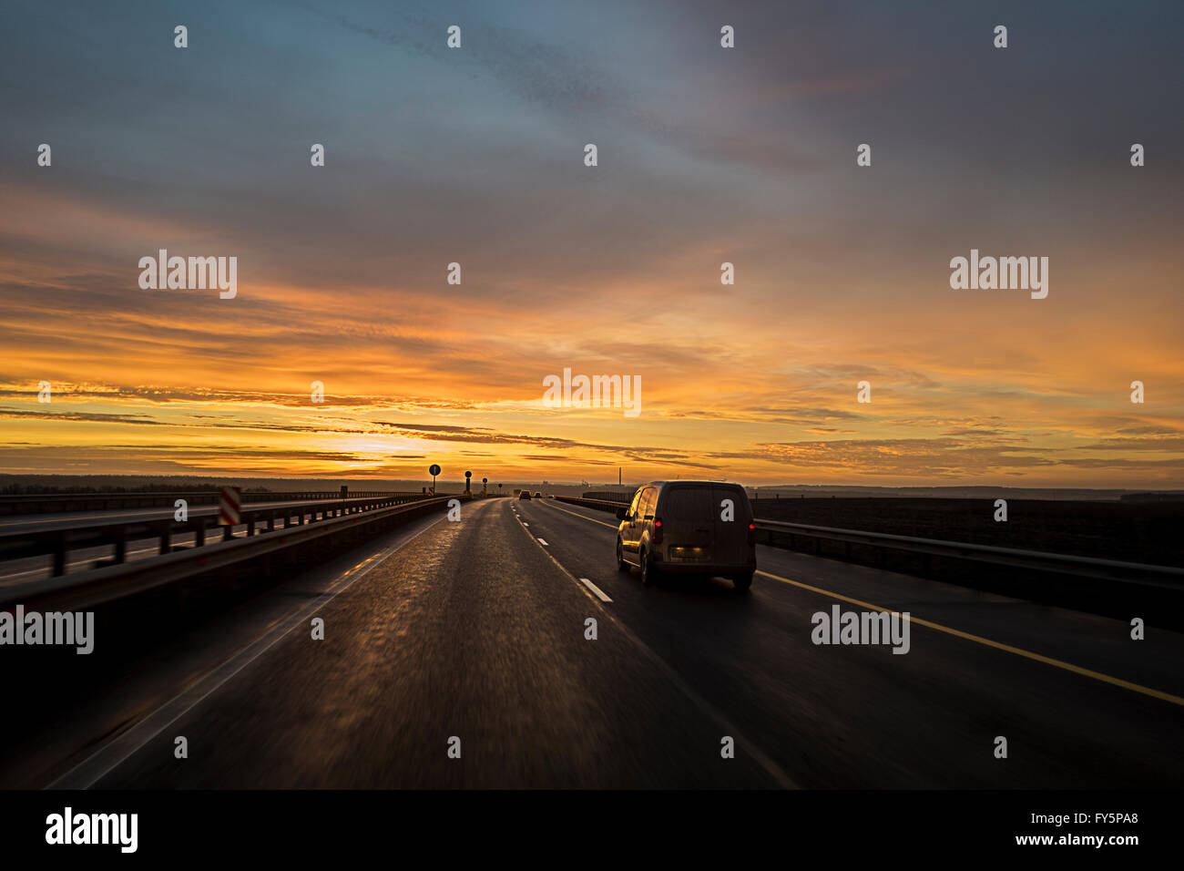 Car is on the sunset road Stock Photo - Alamy