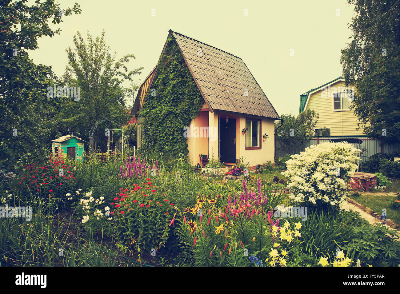 rustic country house in the lush garden Stock Photo - Alamy