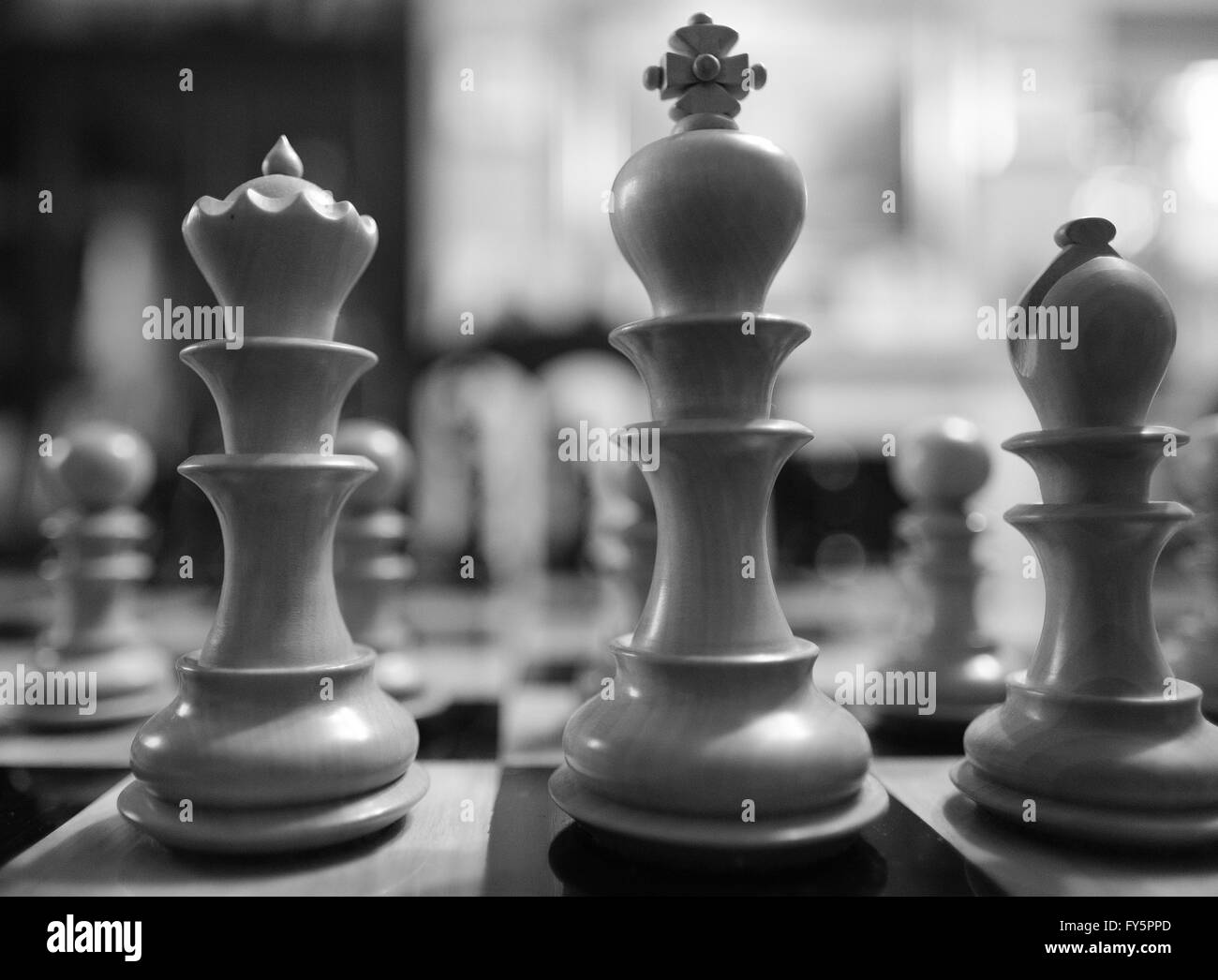 Carved chess pieces in there starting position on a wooden board Stock ...
