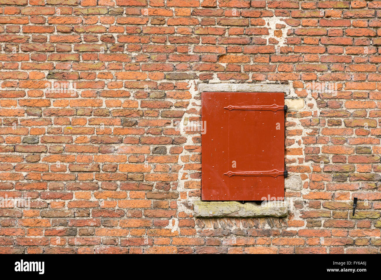 Old fortress wall with a red colored wooden hatch Stock Photo - Alamy