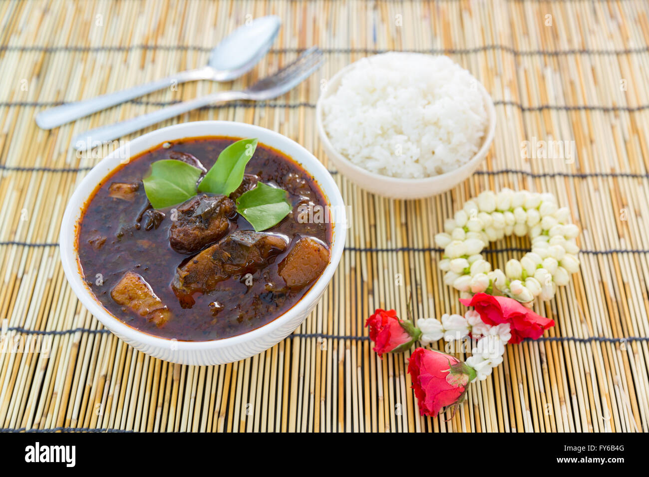 Thai cuisine the Chamuang pork Curry on bamboo mat decorate with thai ...