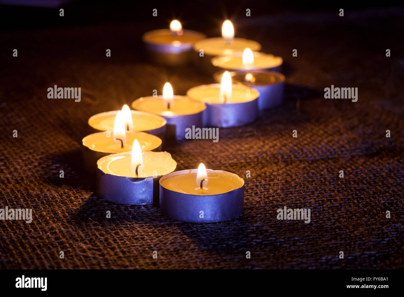 Line of tealight candles in an s shape curve Stock Photo - Alamy