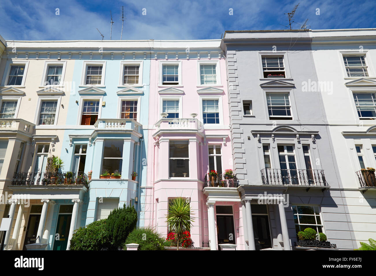 Colorful English houses facades in London, blue sky in a sunny day ...