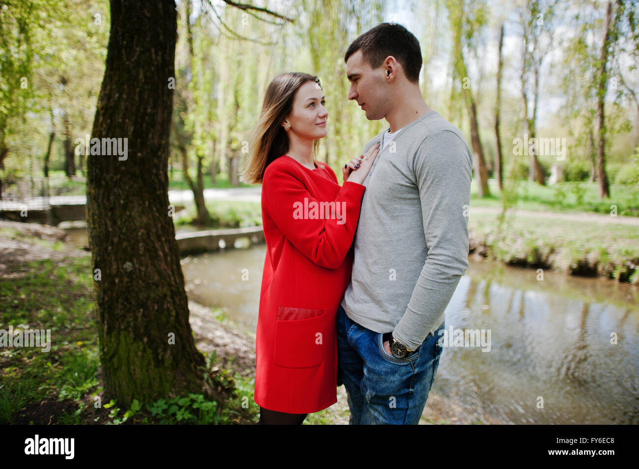 Loving couple stay and look each other at park background river Stock ...
