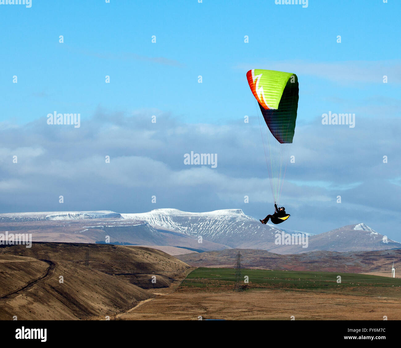 Paraglider soarig with Pen y Fan and Brecon Beacons in background with ...