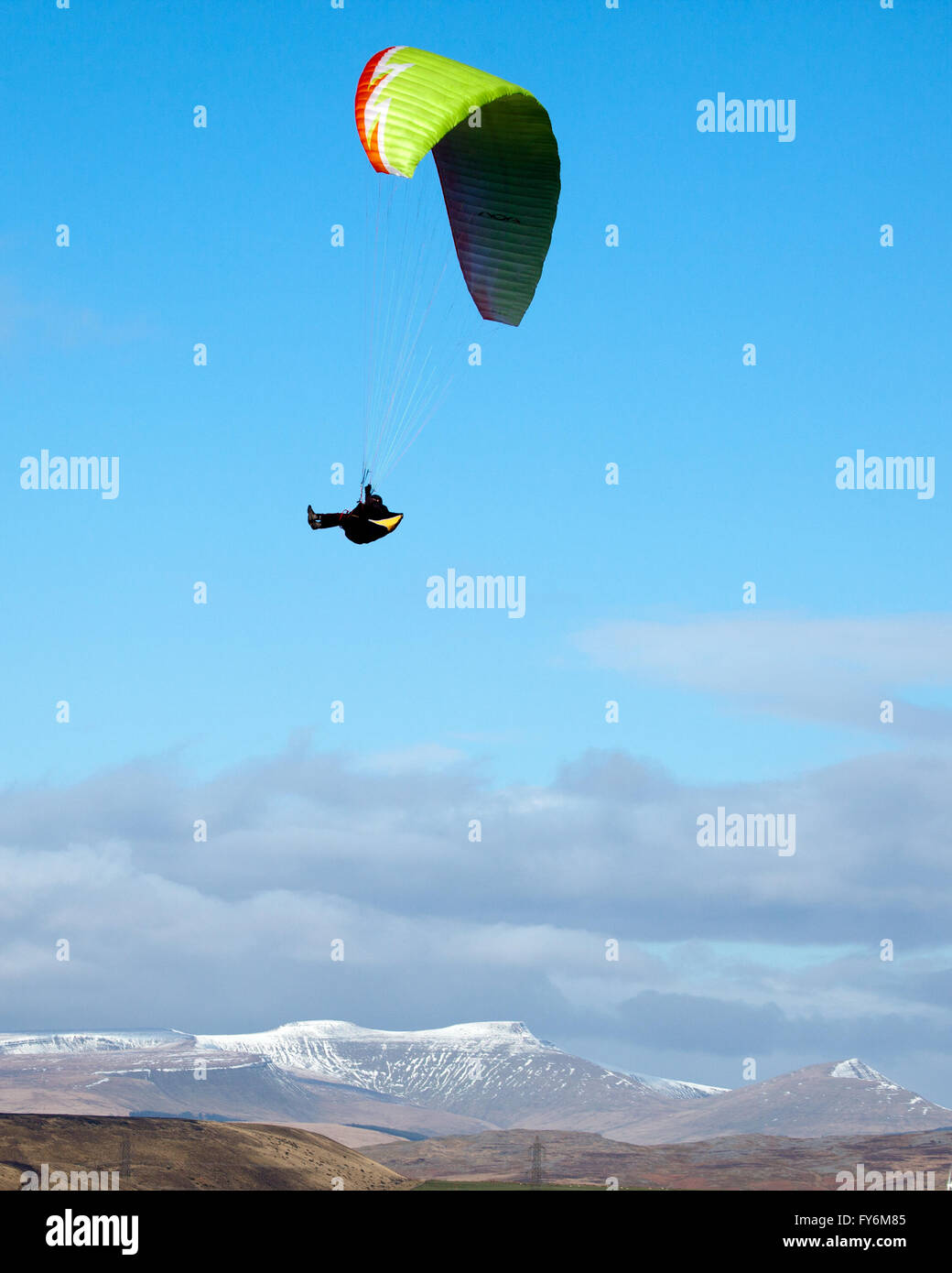 Paraglider soarig with Pen y Fan and Brecon Beacons in background with ...