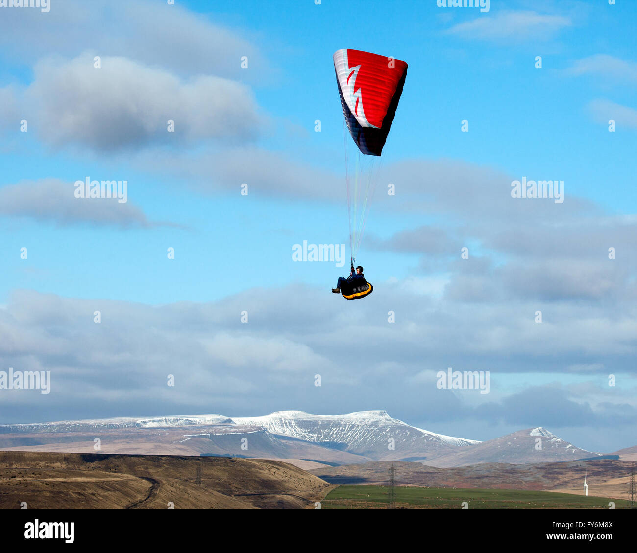 Paraglider soarig with Pen y Fan and Brecon Beacons in background with ...