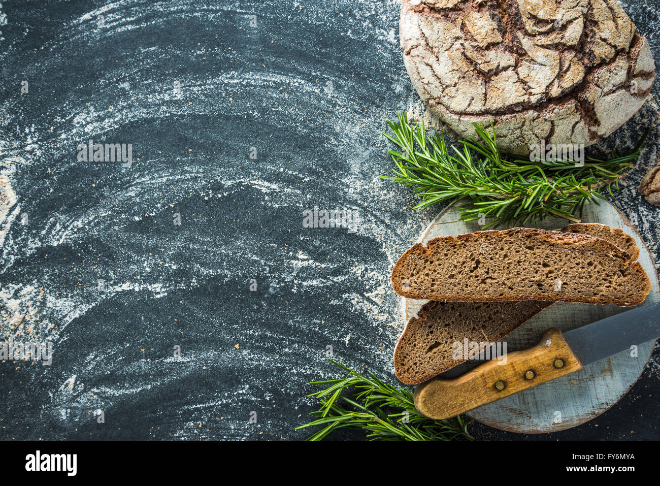 sliced rye artisan bread loaf, on dark slate from above Stock Photo - Alamy