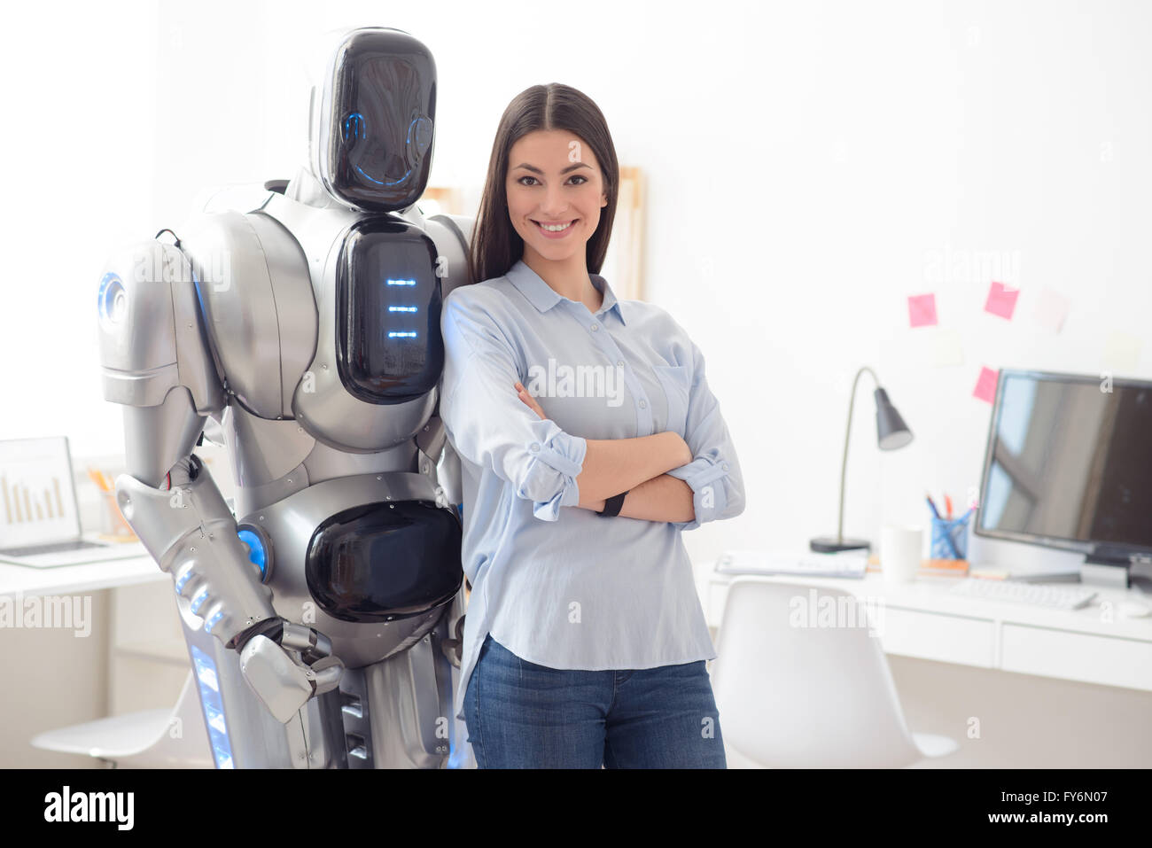 Pleasant girl standing with the robot Stock Photo - Alamy