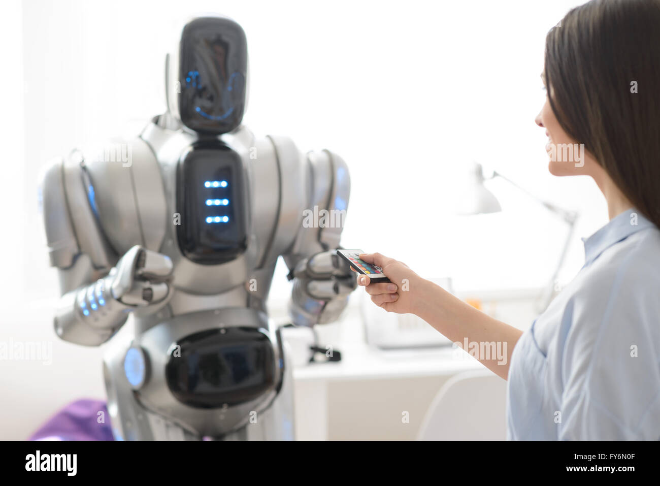 Pleasant girl standing with robot Stock Photo - Alamy