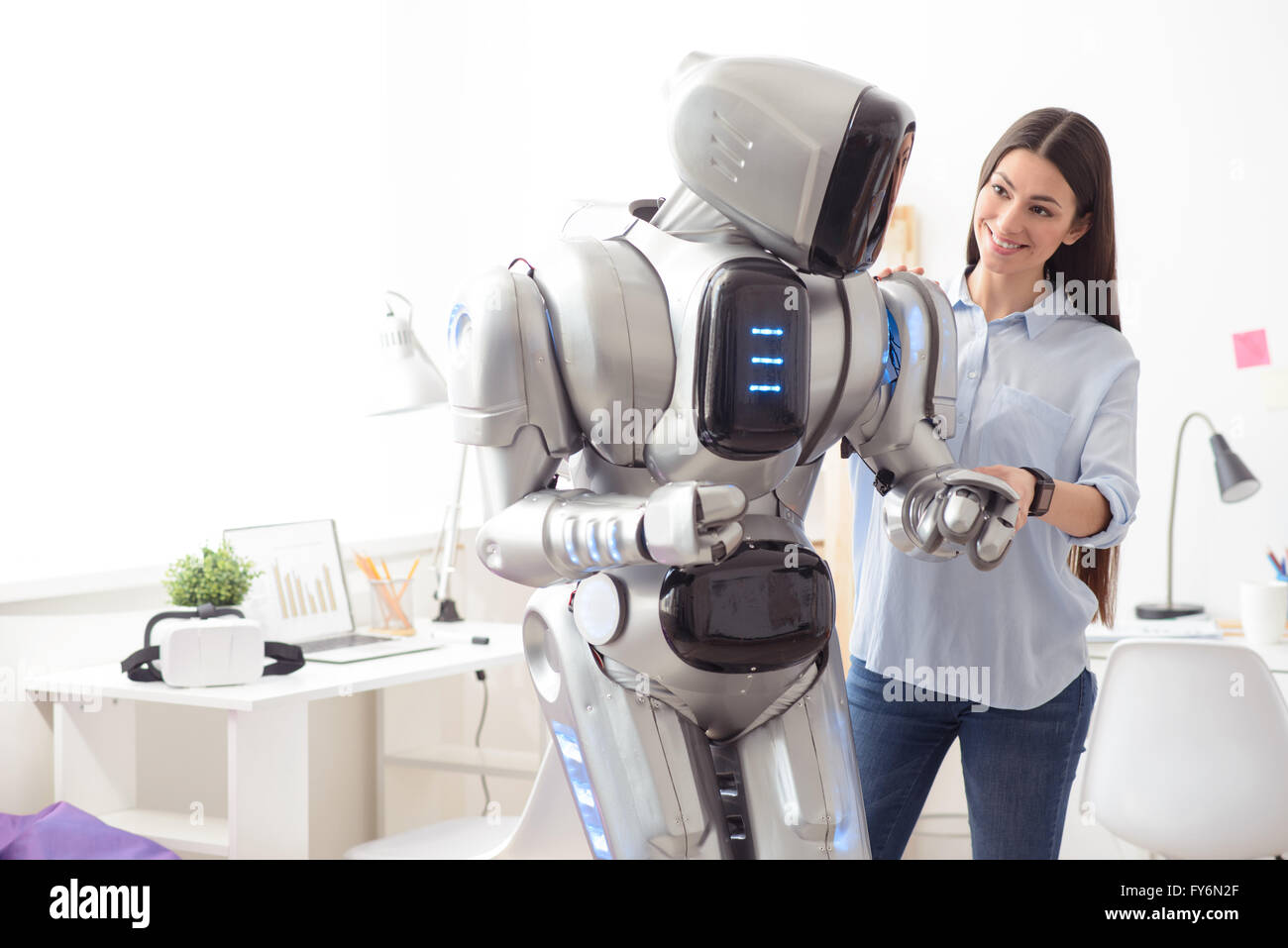 Delighted girl standing with robot Stock Photo - Alamy