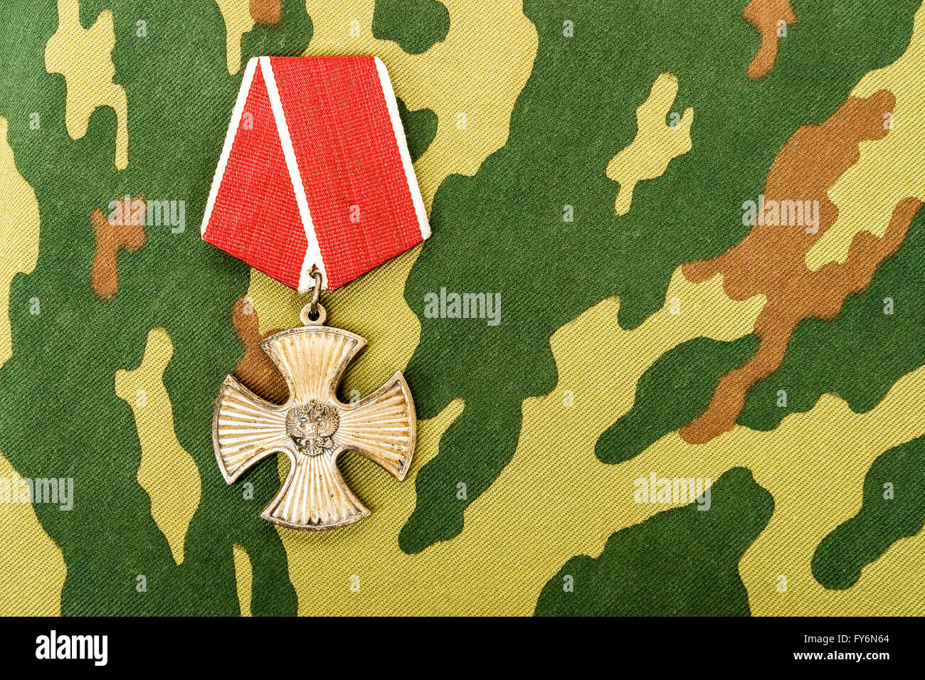 Order of bravery on the camouflage background Stock Photo - Alamy