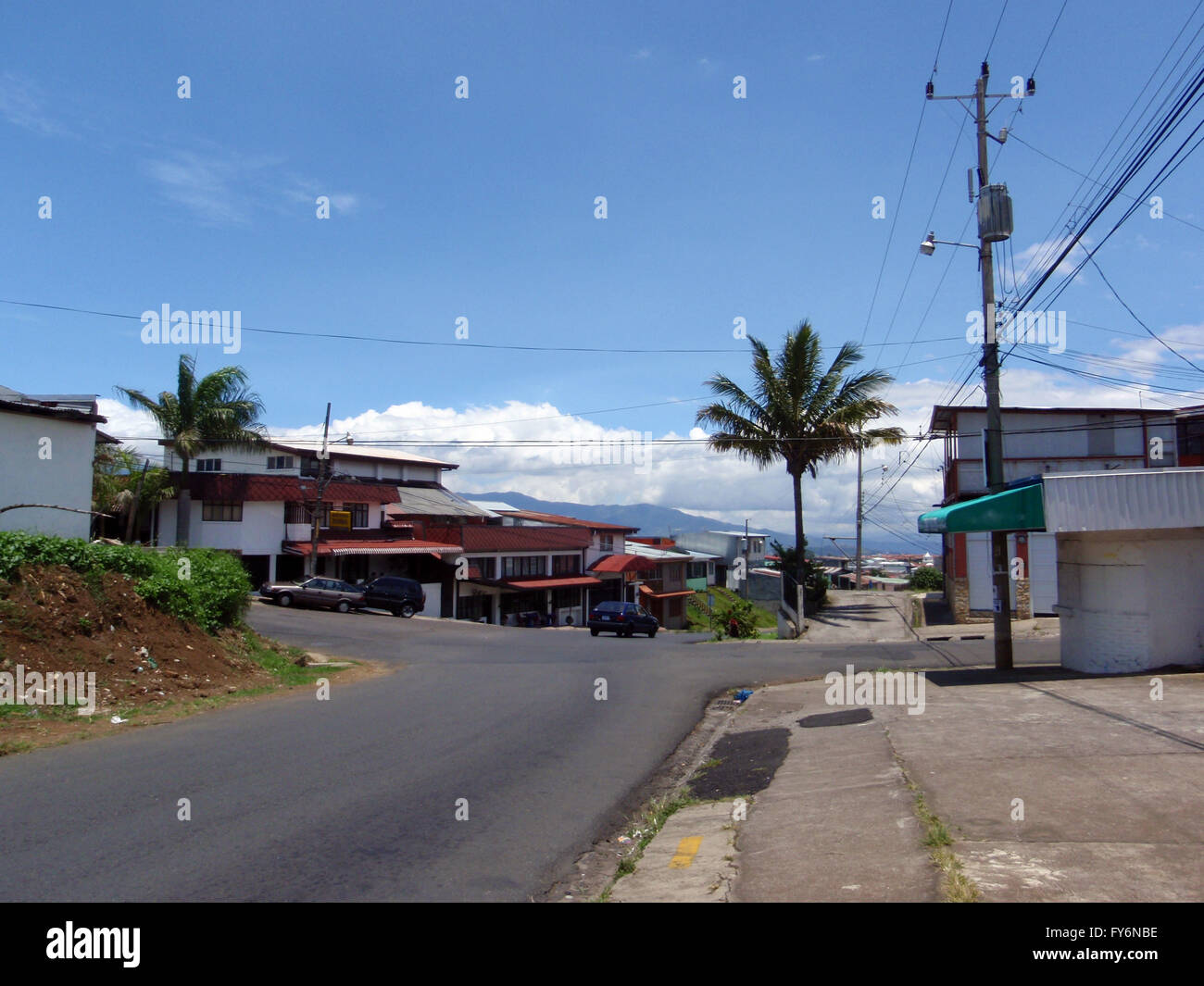 Street lined this house, stores, palm trees and power lines in Heredia ...