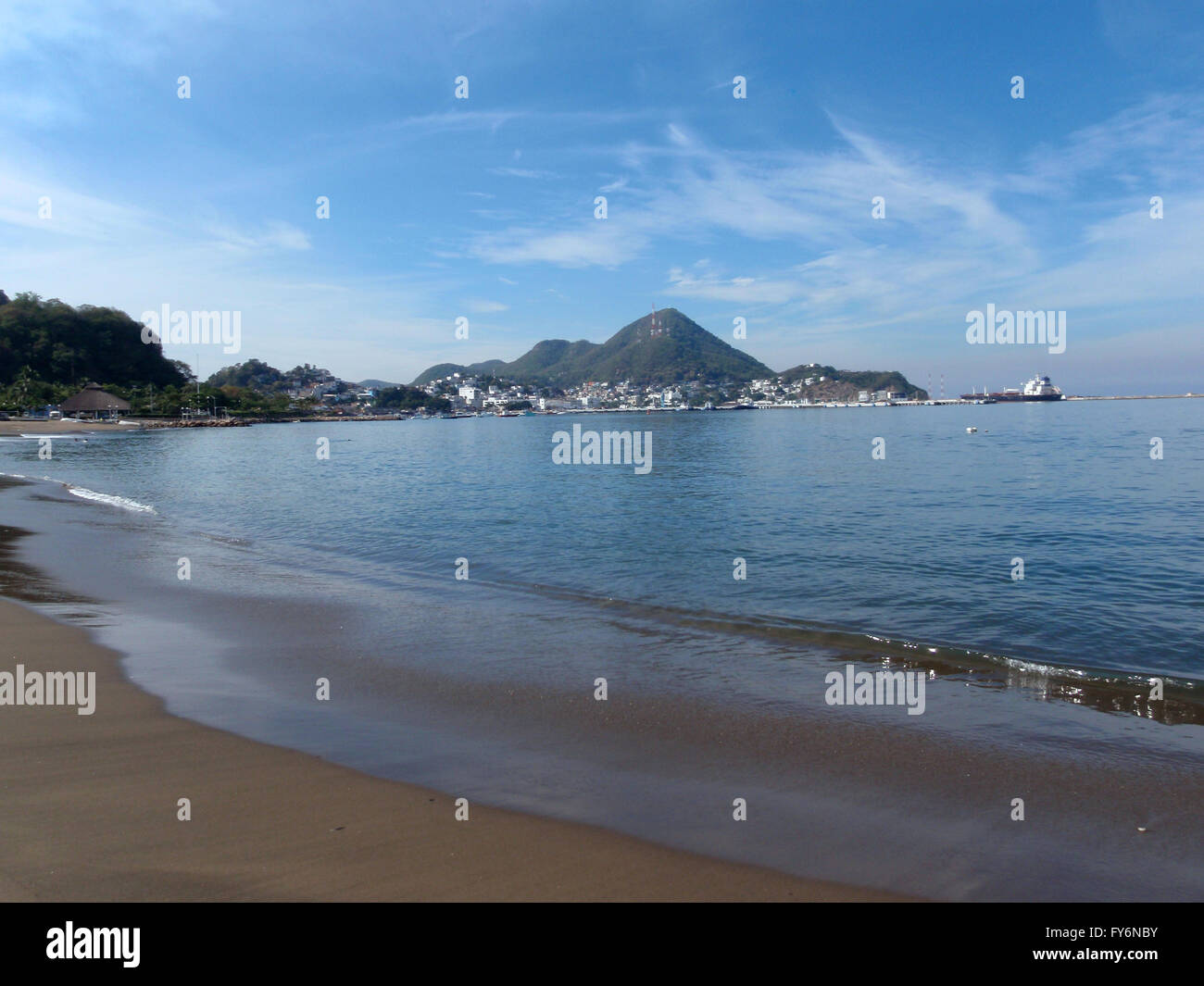 Beach in Manzanillo, Mexico with Town, Mountain, and large cargo boat ...