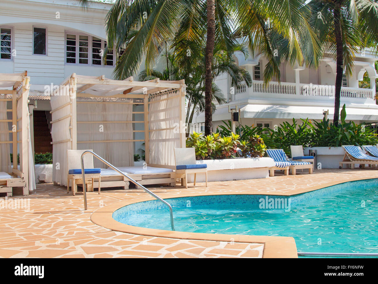 Kolva, India - April 20, 2016: Bright relax travel photo with blue pool ...