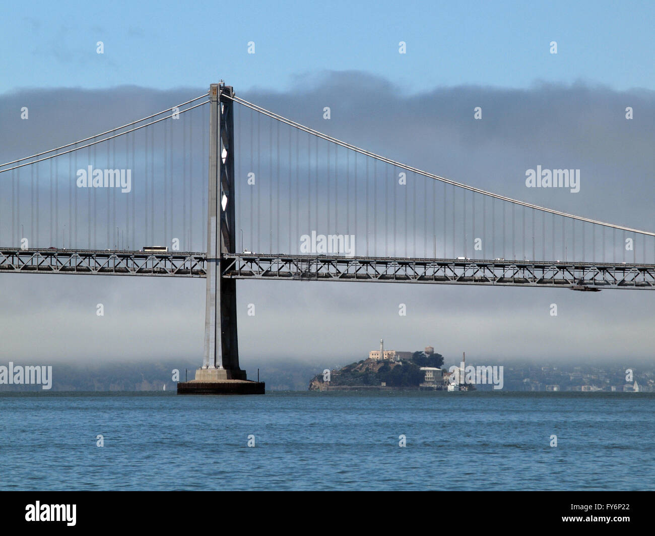 Bay Bridge with cars traveling across it and Alcatraz Island with a ...