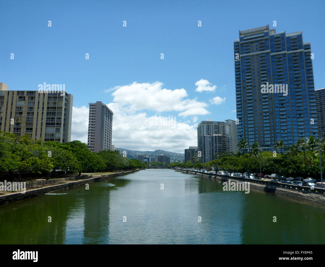 Ala Wai Canal in Waikiki surrounded by tall buildings and trees on Oahu ...
