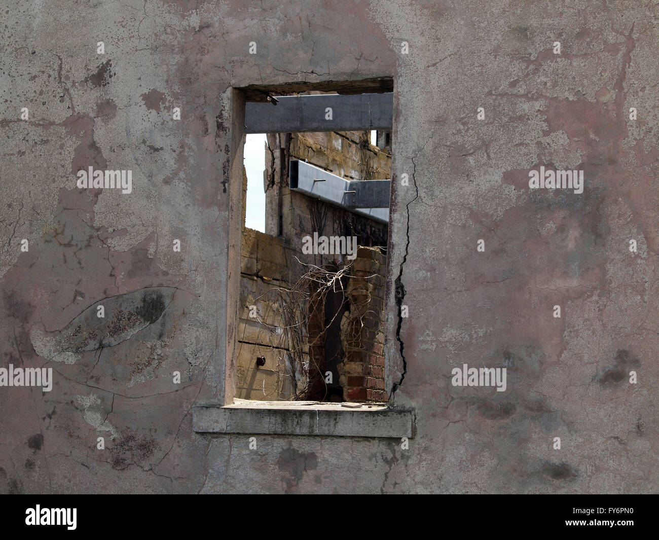 Window opening of ruin down building with the interior falling apart on ...