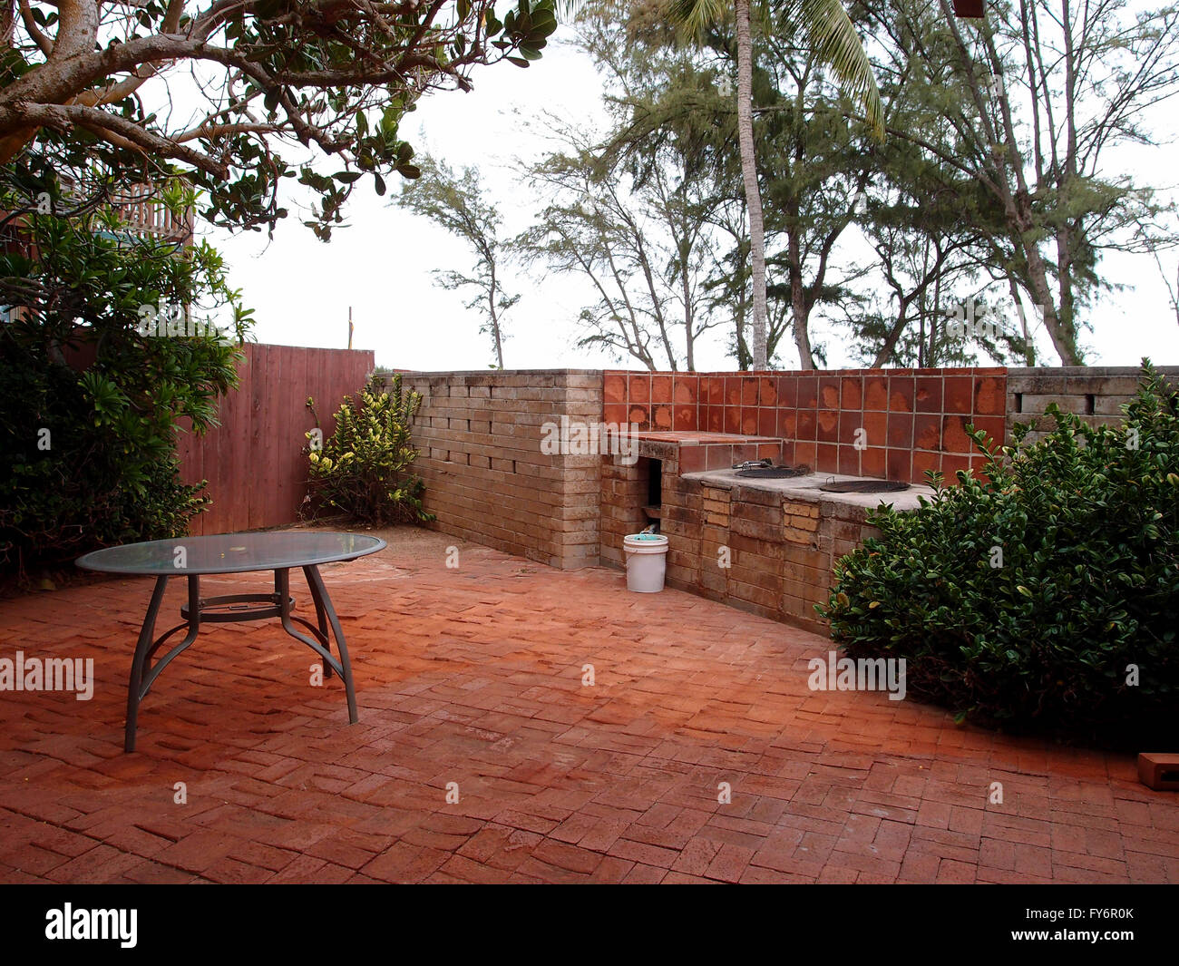 Red Brick Patio with BBQ Pits and table surrounded by trees Stock Photo ...
