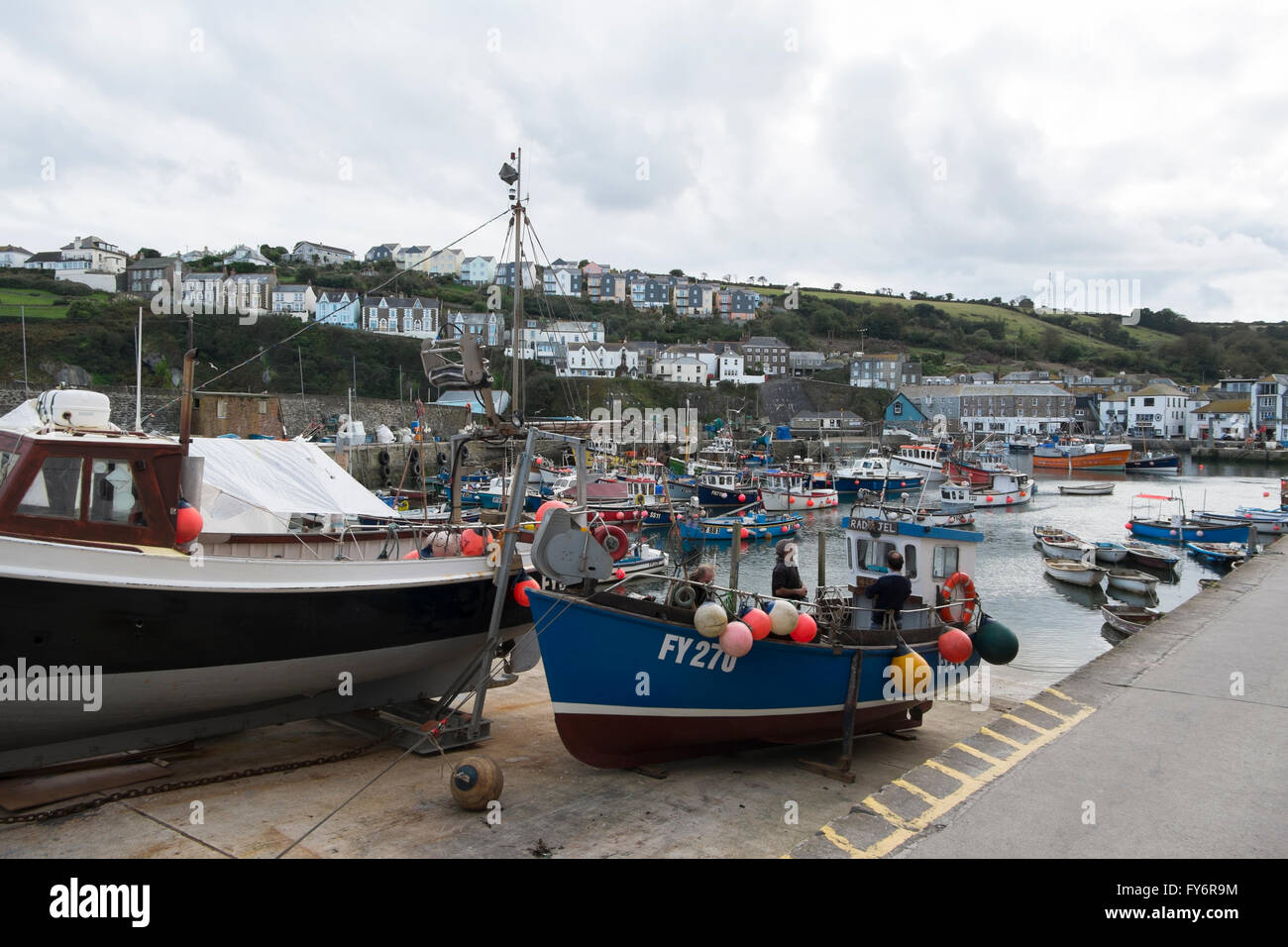 Fishermen on a fishing boat in the harbour at Mevagissey, Cornwall, UK ...