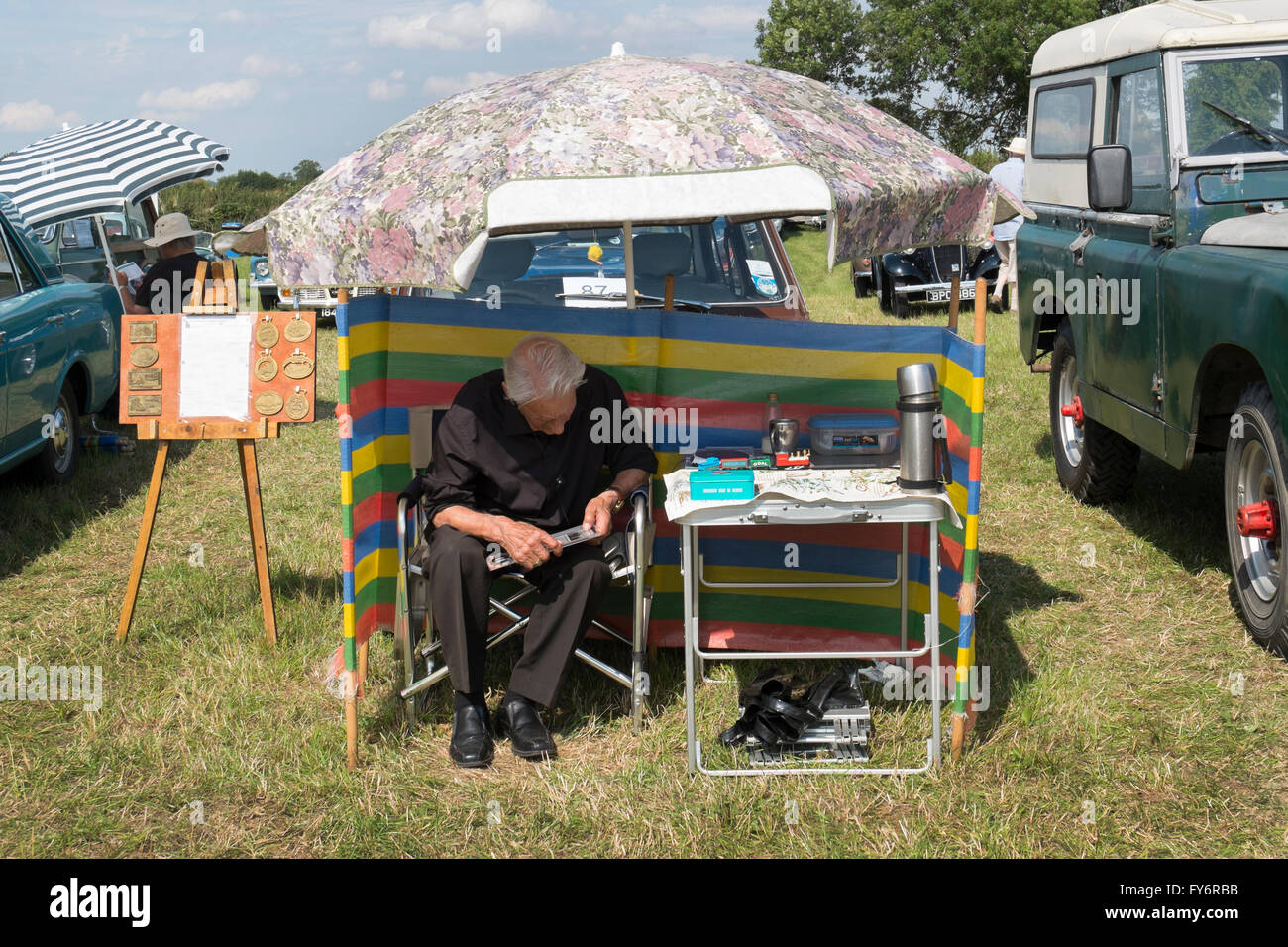 Man displaying his Triumph Dolomite car and traction engine medals at ...
