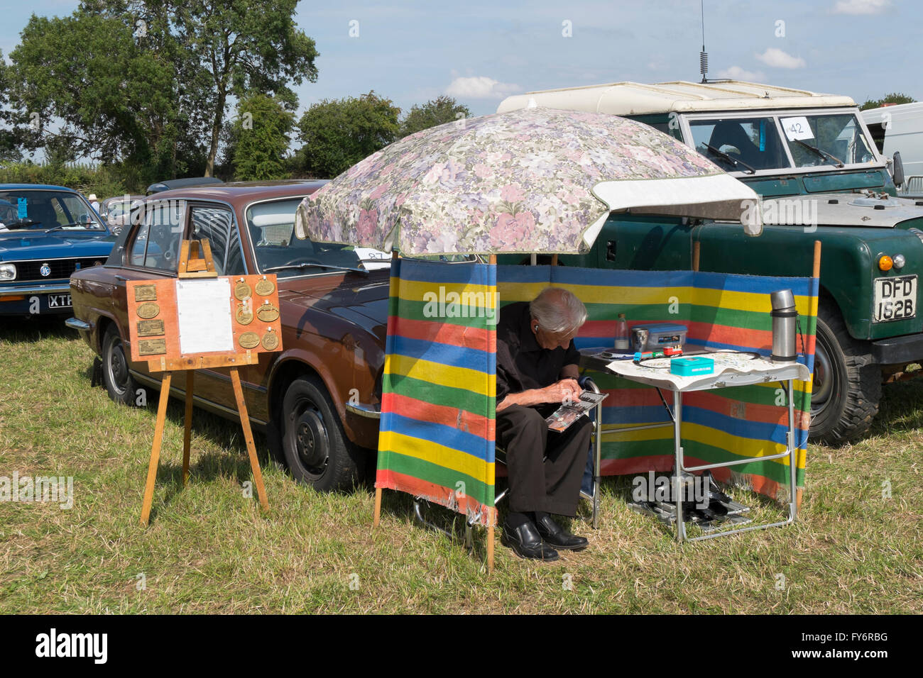 Man displaying his Triumph Dolomite car and traction engine medals at ...