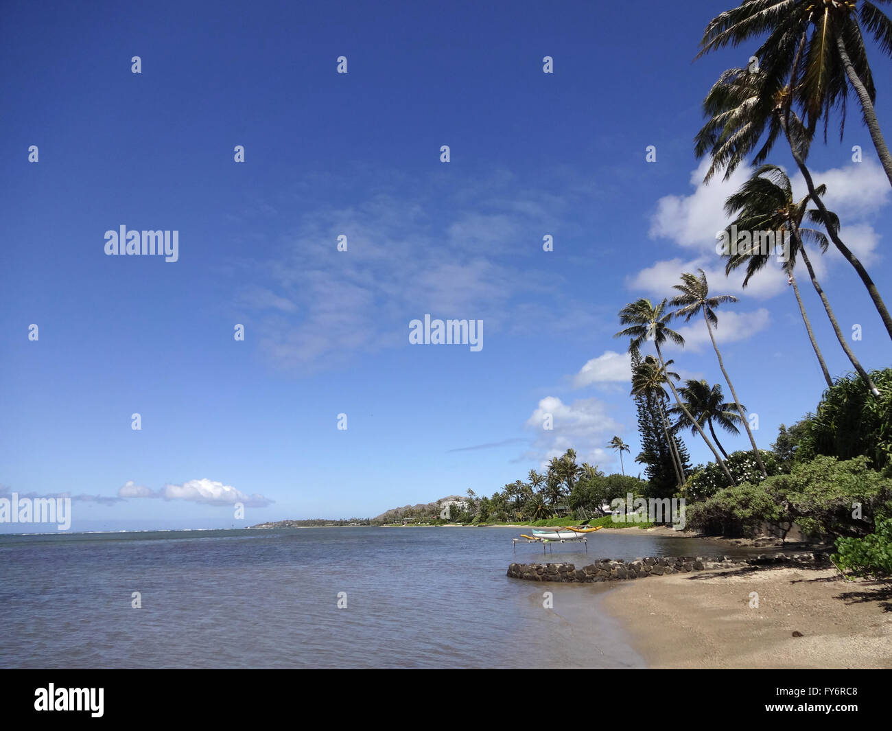 Calm Shoreline with a canoe on stilts at Wailupe Beach Park on Oahu ...