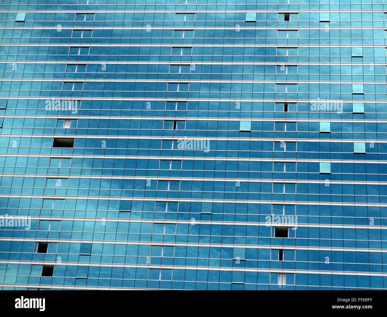 Blue Glass Windows reflect clouds and Sky with some windows open Stock ...