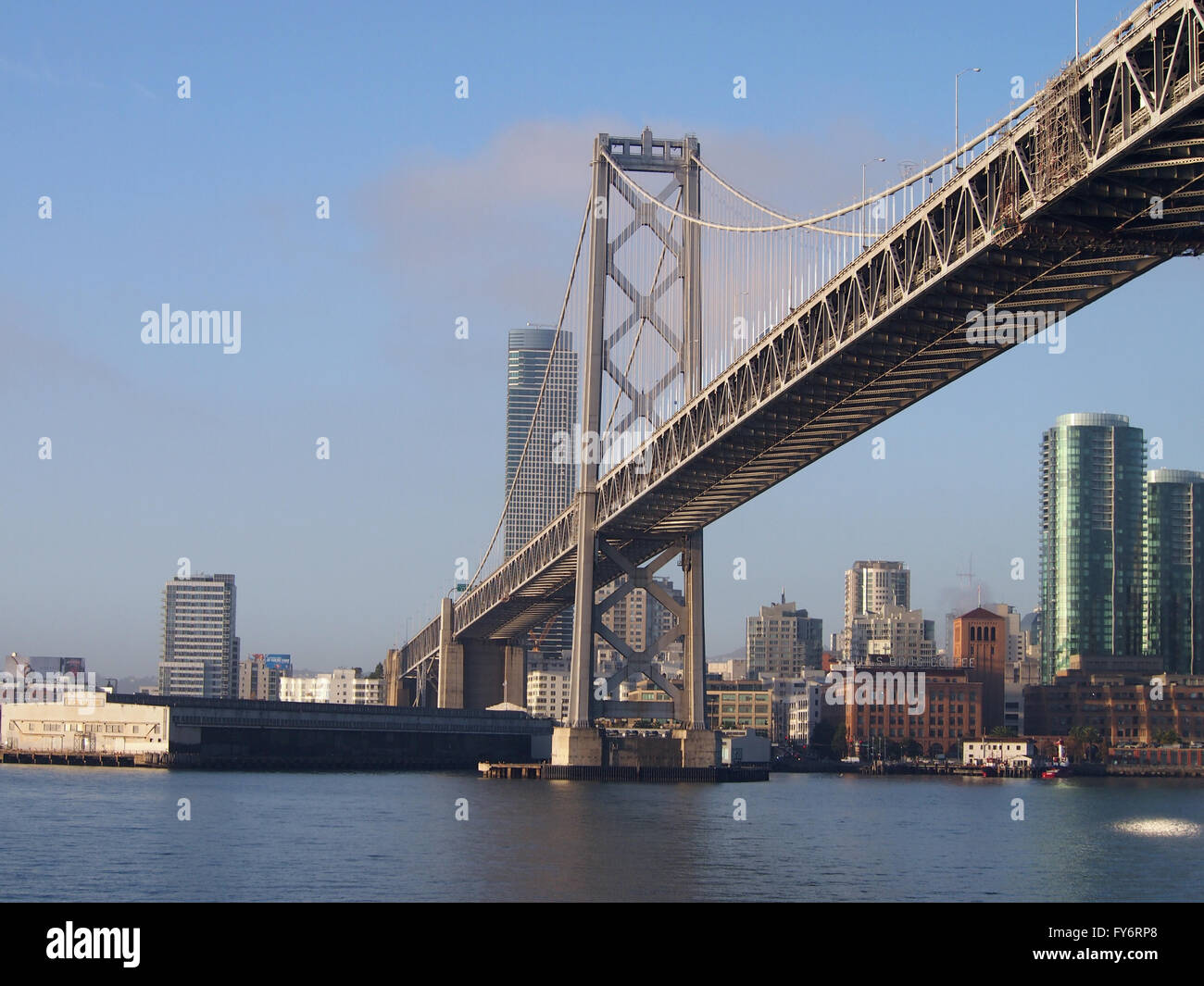 San Francisco side of Bay Bridge from ferry boat sailing underneath ...