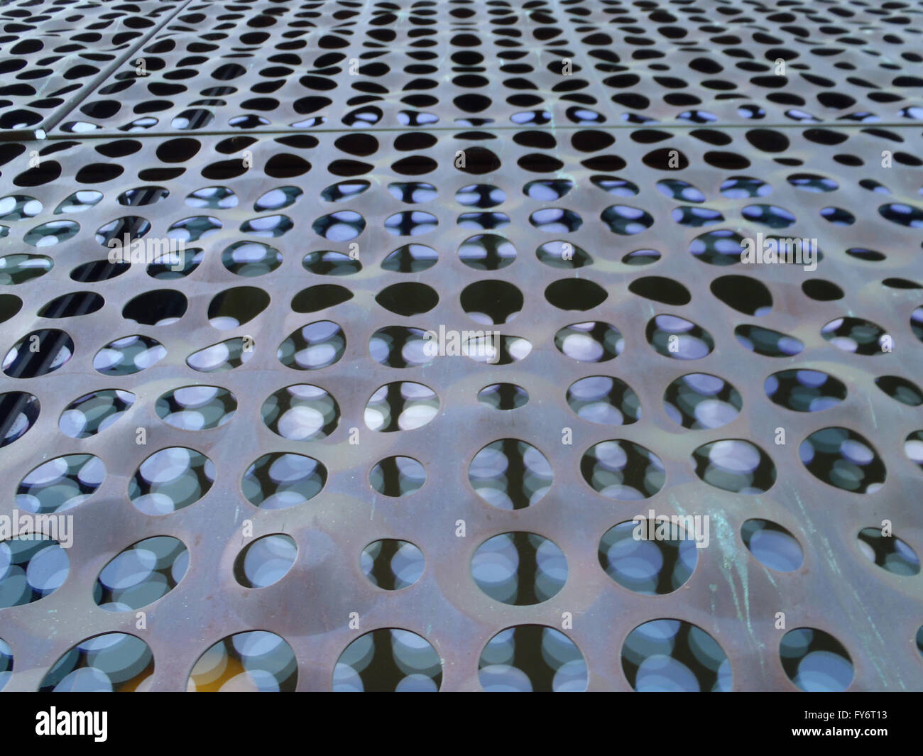 Hole patterns let in the light going upward on a building Stock Photo ...