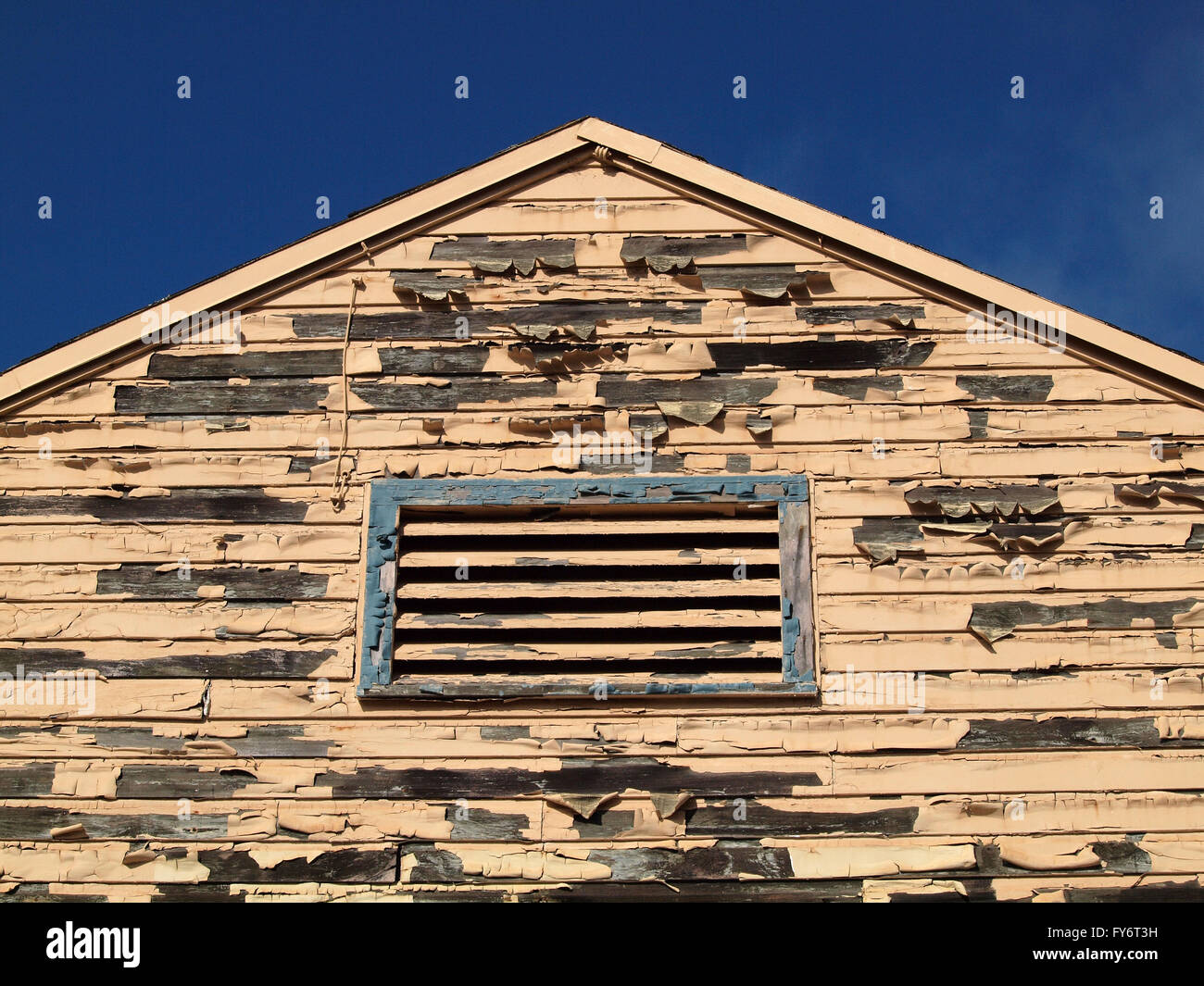 Paint chips on Building with blue sky Stock Photo - Alamy
