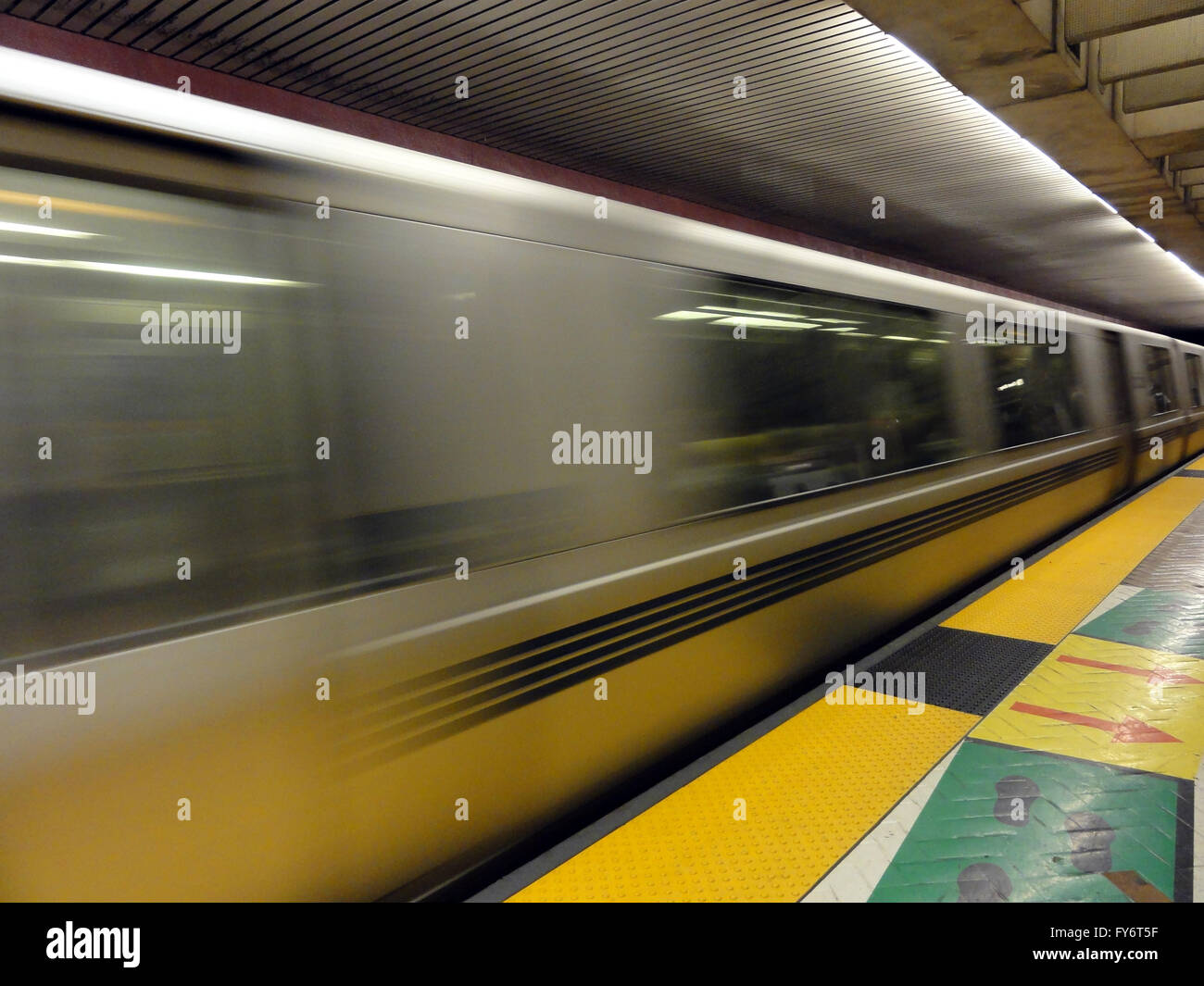 Train speeds through underground station Stock Photo - Alamy