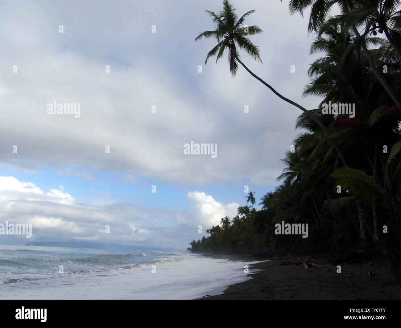 waves lap on remote dark sand beach in Punta Banco, Costa Rica Stock ...