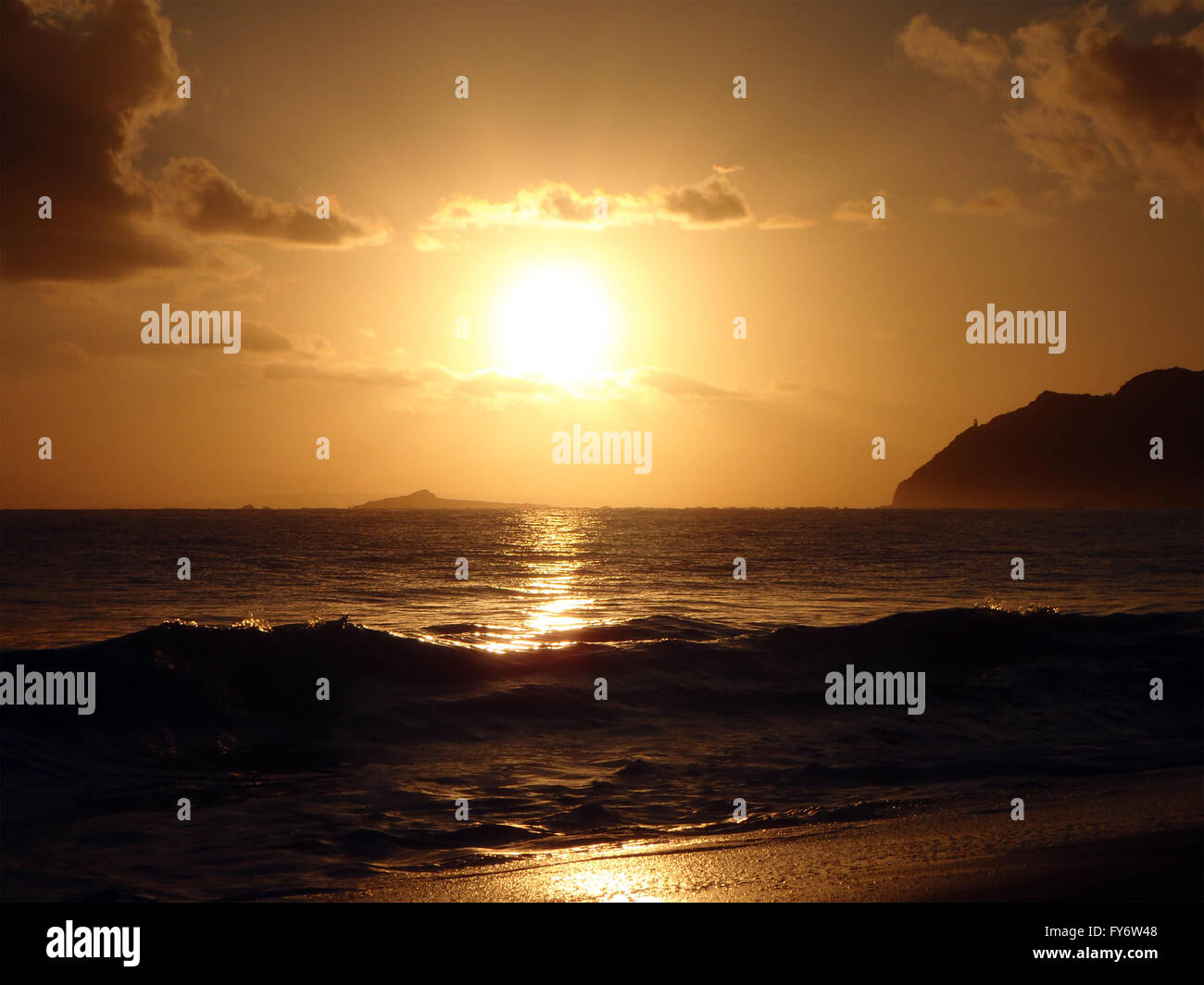 Sunrises over Rock Island by Maka'pua Point on Oahu, Hawaii Stock Photo ...