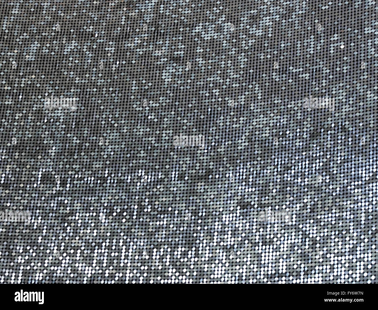 Pattern of Circles of silver metal shimmer in the light each doing ...