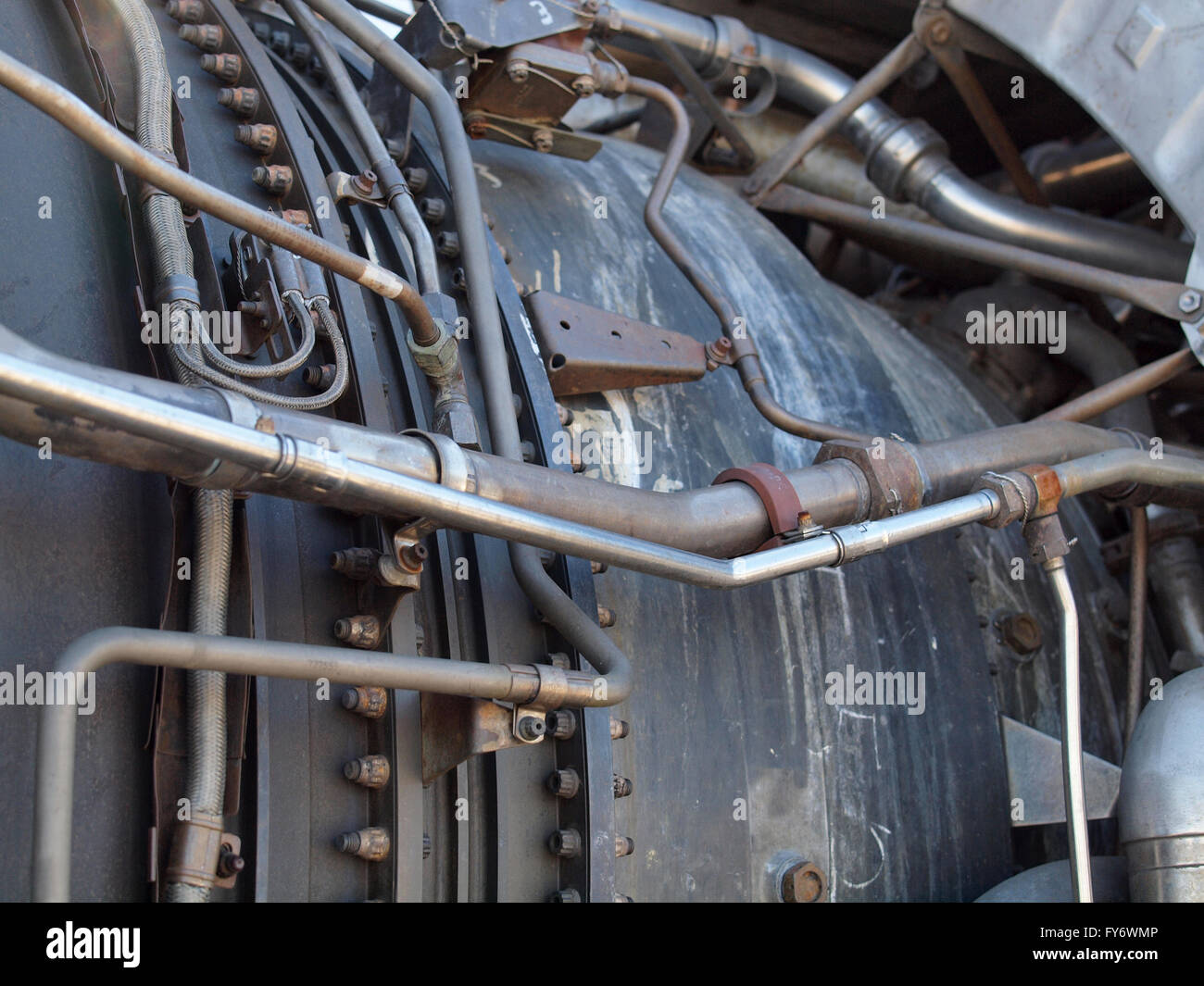 Close-up of tubes running along side of gray jet engine Stock Photo - Alamy
