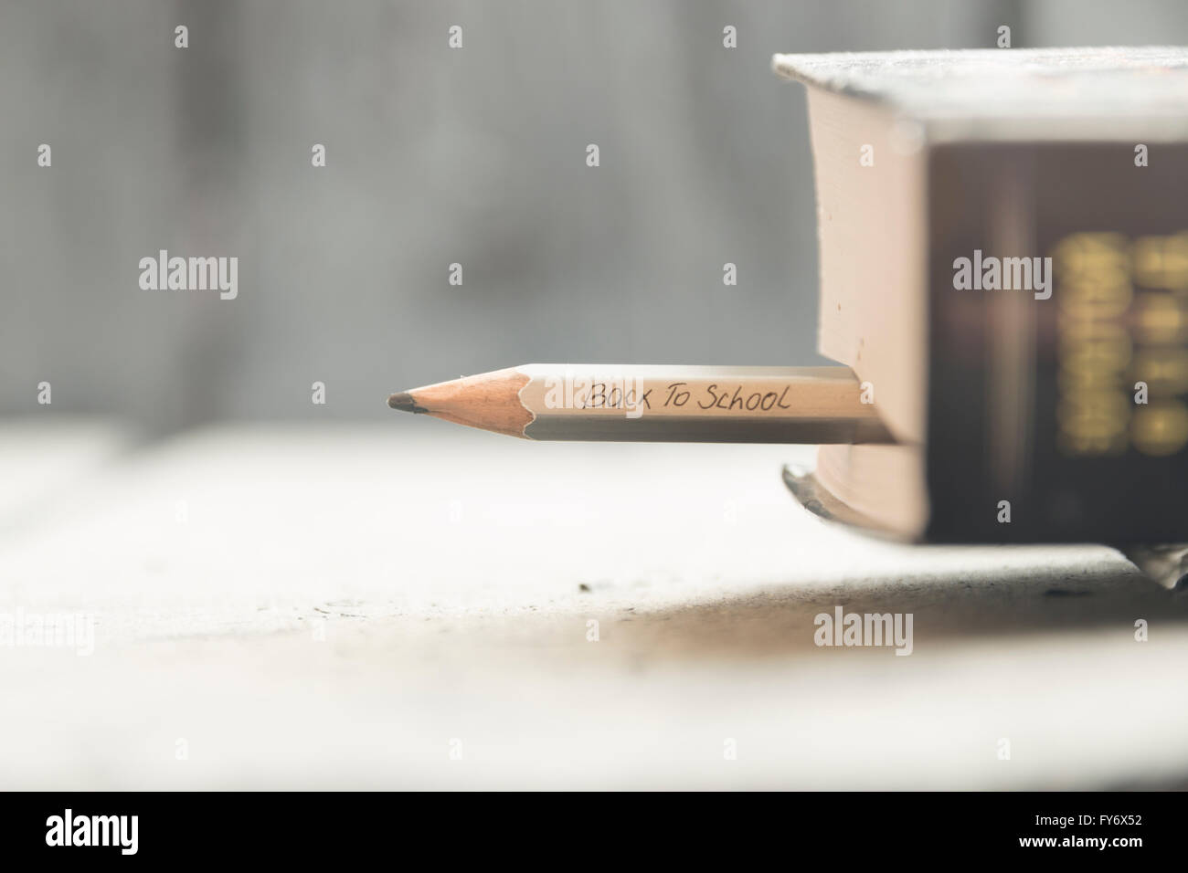 back to school - inscription in pencil and book Stock Photo - Alamy