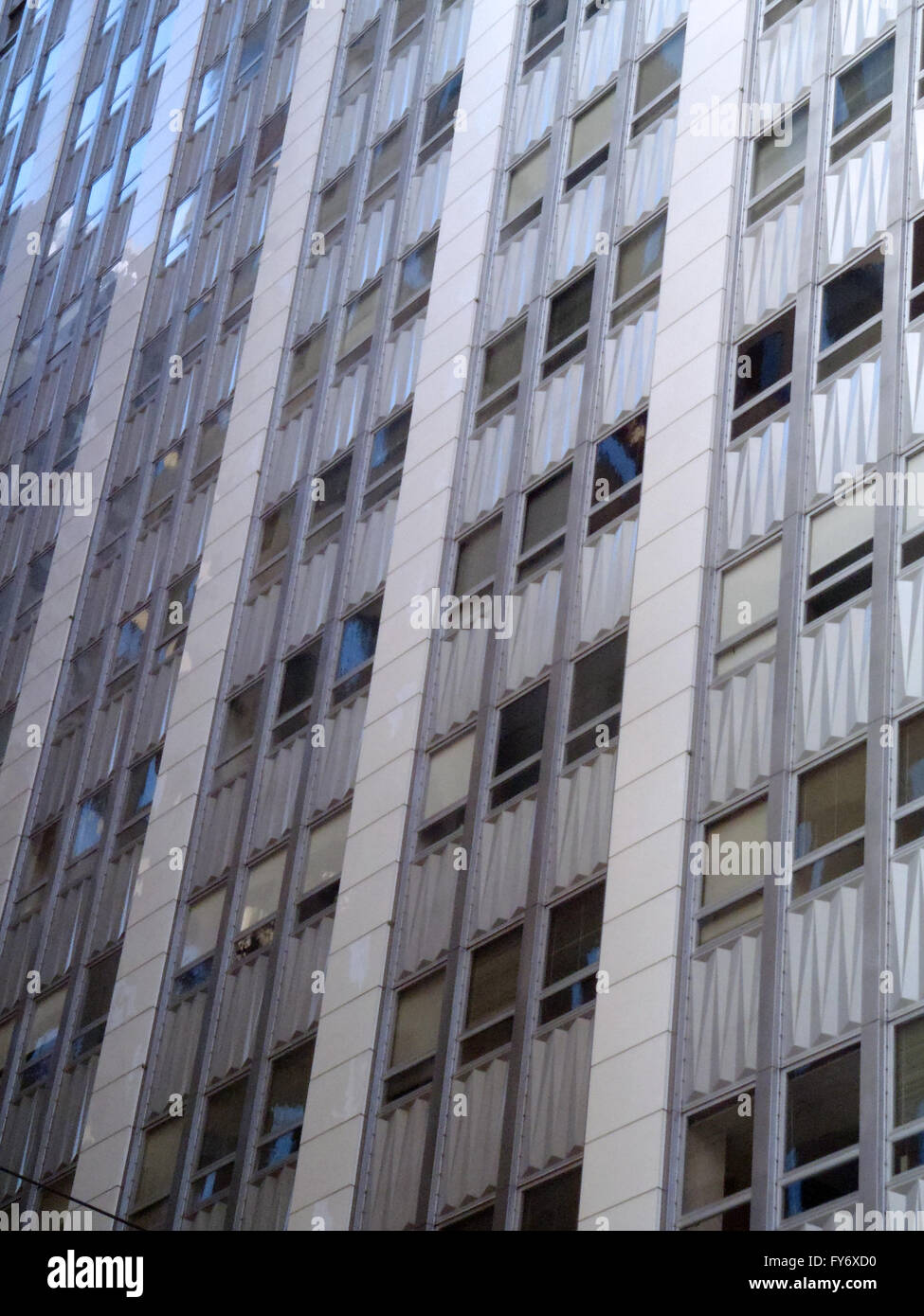 Classic Modern building with many windows reflectioning light in San ...