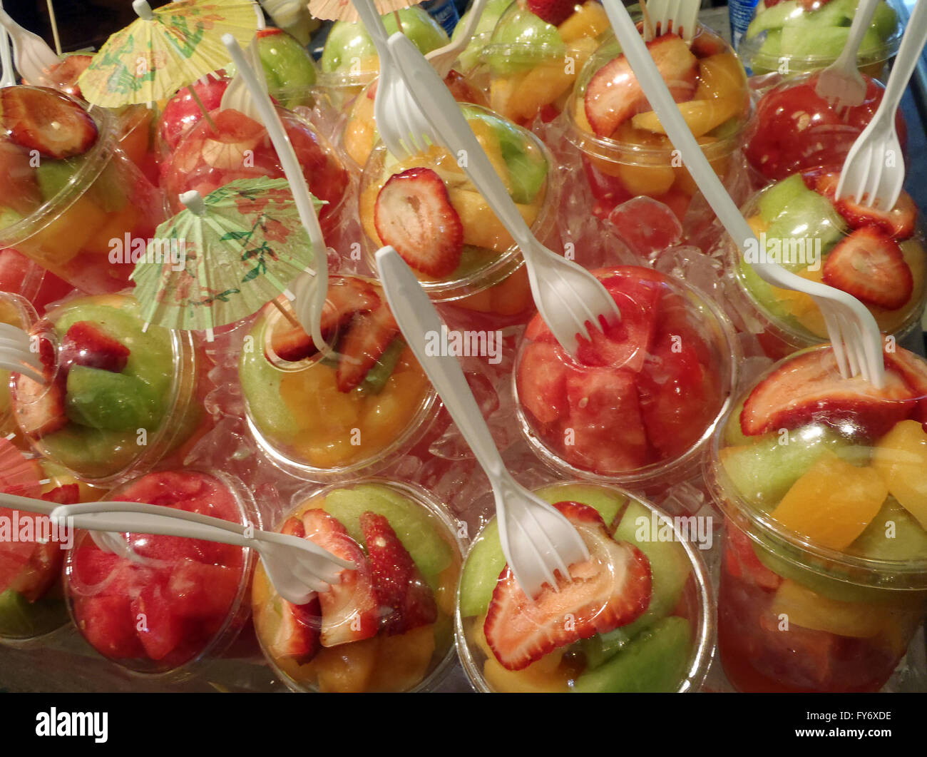 Plastic Fruit cups with forks placed in the top on display in a tray ...