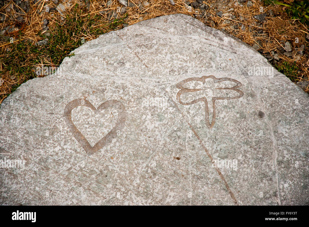 Heart and firefly decorations in stone Stock Photo - Alamy