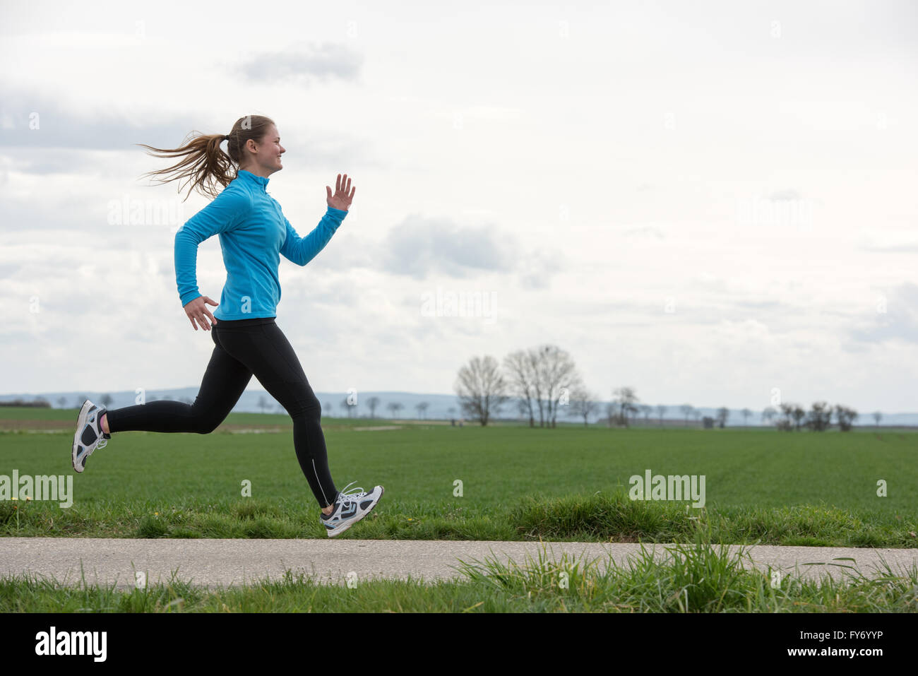 young woman jogging (running) outdoors Stock Photo - Alamy