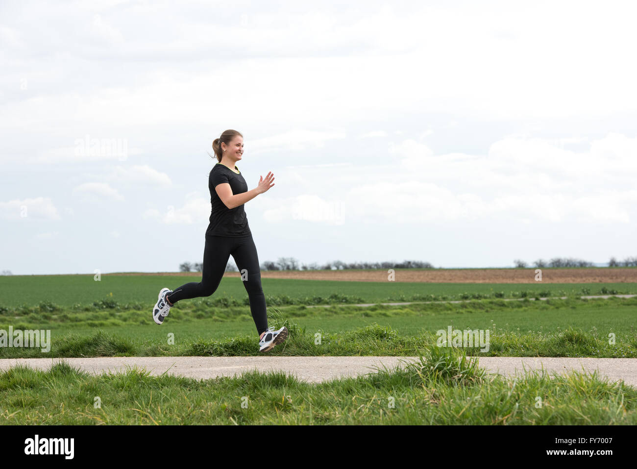 Woman 40s running road hi-res stock photography and images - Alamy