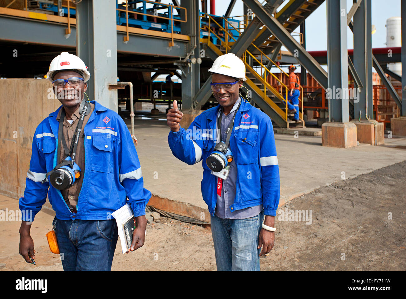 Two copper mine employees smiling and giving thumbs up Stock Photo - Alamy