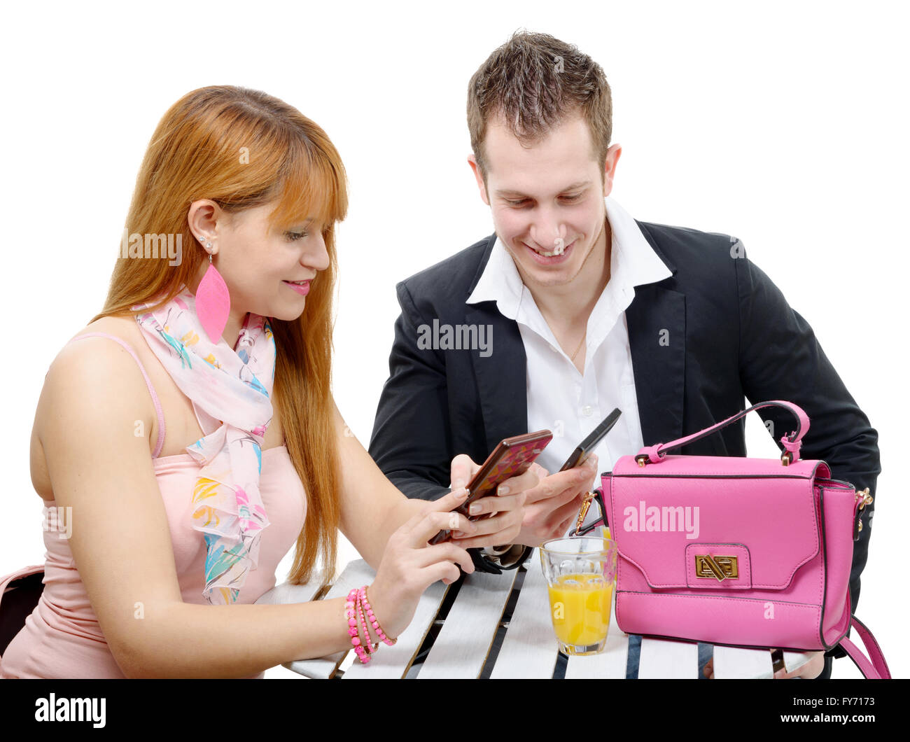 a happy couple with phones isolated on white background Stock Photo - Alamy