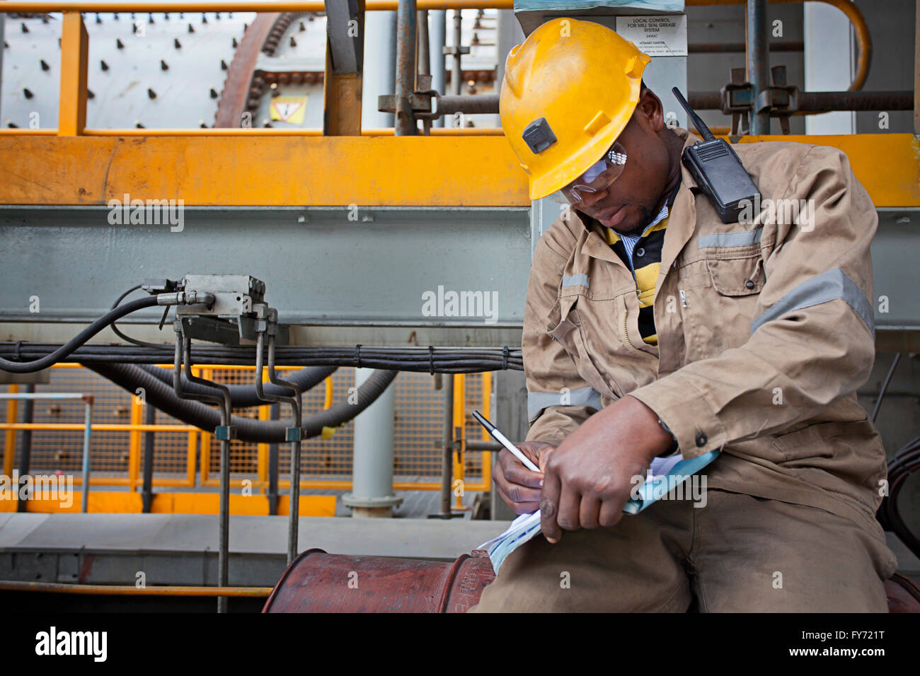 FQML employee at Sentinel copper mine writing in his log book Stock ...